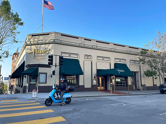The iconic green awnings of Harris' Restaurant stand as beacons of culinary tradition on San Francisco's Van Ness Avenue, promising timeless dining excellence.