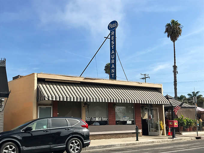 The iconic blue vertical sign beckons hungry travelers like a lighthouse for breakfast sailors adrift on a sea of morning hunger.