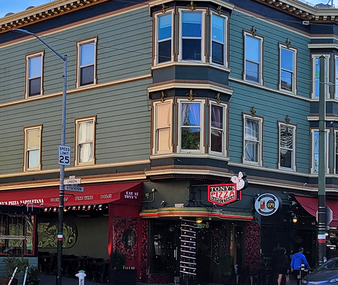 The iconic green and red corner building of Tony's Pizza Napoletana stands proudly in San Francisco's North Beach, a beacon for pizza pilgrims from across California.