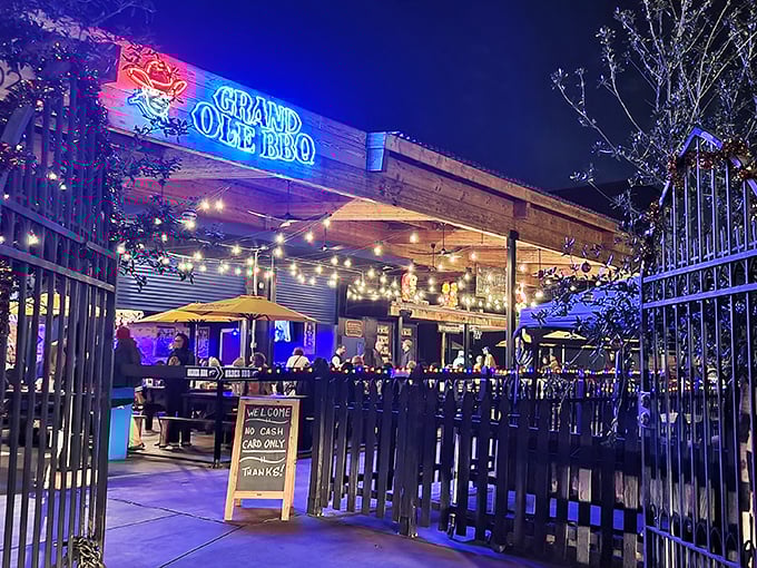 Stepping through the gates into BBQ paradise. The string lights and smoke hint at the legendary feast waiting inside this San Diego gem.