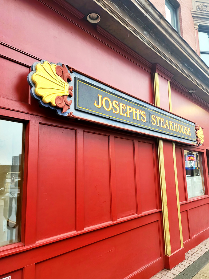 That gold-lettered sign against the crimson exterior isn't just decoration&mdash;it's a portal to a world where steak reigns supreme.