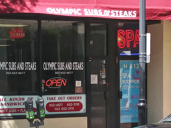 That classic red awning and neon "OPEN" sign &ndash; the culinary equivalent of a lighthouse guiding hungry souls to sandwich salvation.