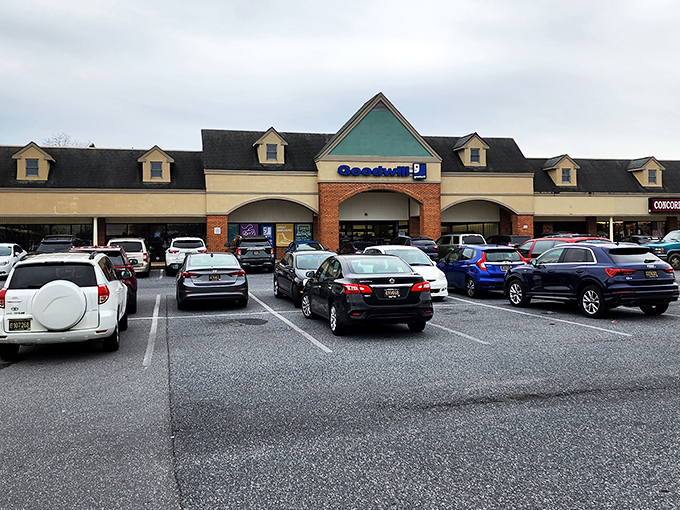 From this angle, you can see why locals flock here. The distinctive teal triangle roof and dormer windows make this Goodwill impossible to miss, even in a crowded shopping center.