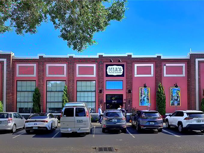 That brick facade with its bold pink panels and vintage signage announces you've arrived somewhere special in Orlando's dining scene.