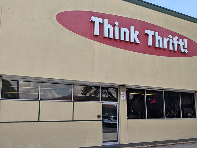 The iconic red oval logo of Think Thrift beckons bargain hunters like a retail lighthouse in a sea of overpriced shopping options.
