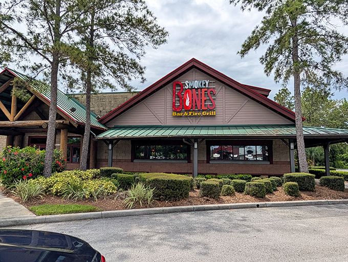 Another angle of the welcoming lodge-like facade, where tall pines frame the entrance as if saying, "Yes, you've found barbecue paradise."