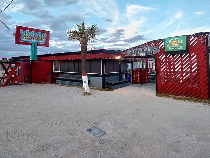 The crimson facade of High Tides at Snack Jack glows at dusk, a beacon for hungry beachgoers seeking seafood salvation on Flagler Beach.