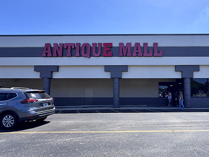 The iconic red lettering of Lakeland Antique Mall beckons treasure hunters like a siren song on a rainy Florida afternoon.