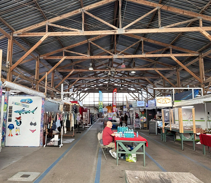 The soaring wooden beams of Fleamasters create a cathedral of commerce where treasure hunters worship at the altar of the unexpected find.