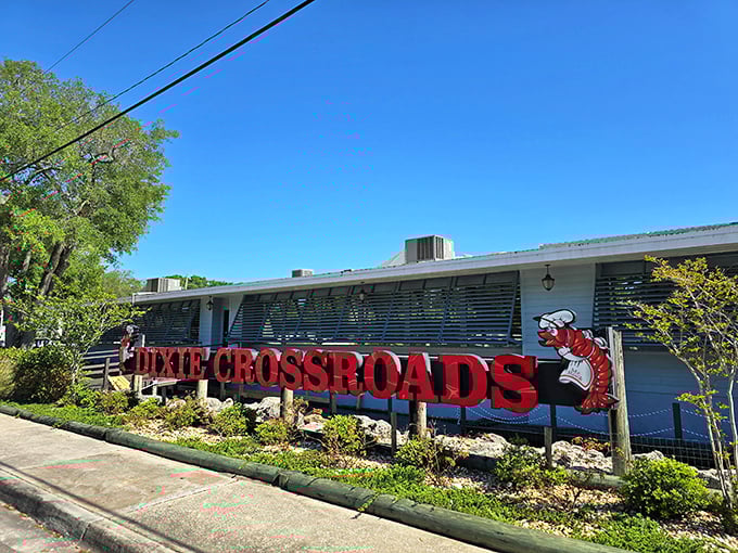 The iconic red shrimp mascot welcomes hungry travelers to Dixie Crossroads, a seafood sanctuary worth the drive.