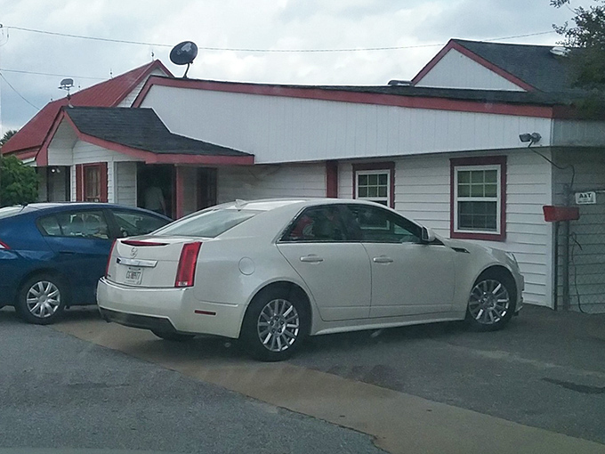 The unassuming white exterior of Zeb's might not scream "culinary destination," but those cars in the parking lot tell the real story.