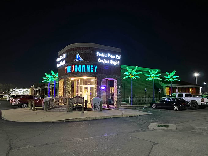 The Journey's nighttime exterior glows like a culinary lighthouse, complete with nautical-themed entrance and palm trees that whisper, "Yes, seafood in Indiana is actually possible!"