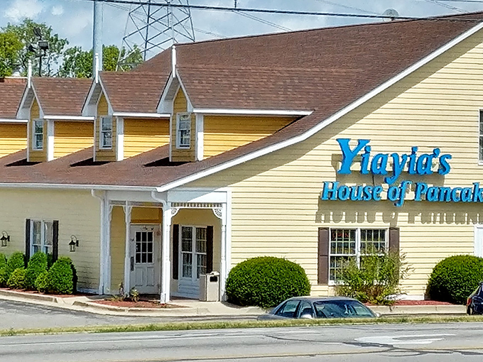The cheerful yellow exterior of Yiayia's stands out like a breakfast beacon in Greenwood, promising pancake perfection within those welcoming walls.