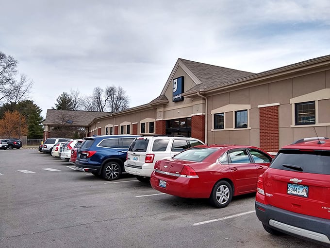 The Taylorsville Road Goodwill stands ready for treasure hunters, its blue sign a beacon for bargain enthusiasts across Louisville.
