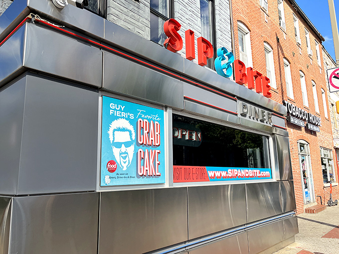 The iconic Sip & Bite exterior gleams in Baltimore sunlight, its retro signage promising culinary time travel and Guy Fieri-approved crab cakes just beyond those doors.