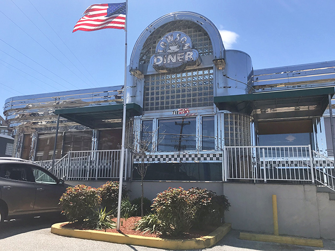 That iconic sign beckons hungry travelers like a lighthouse for the breakfast-starved, promising comfort food and bottomless coffee under Maryland skies.