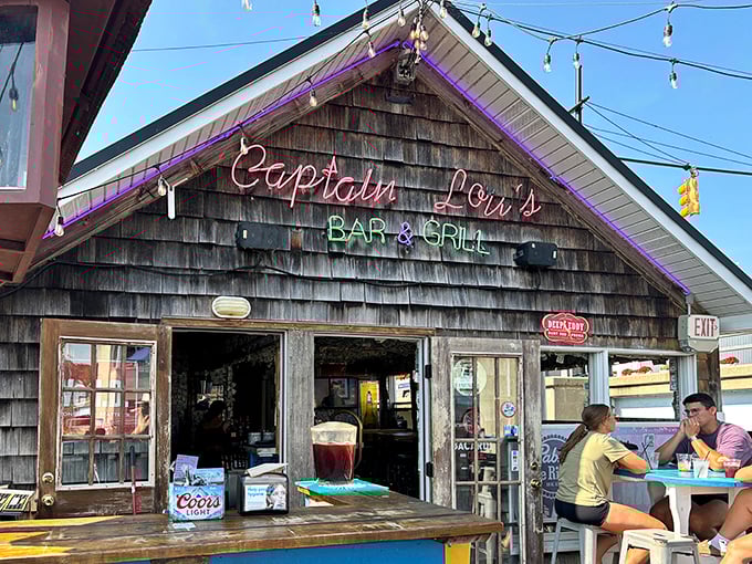 The weathered cedar shake facade and neon glow scream "authentic harbor joint" &ndash; no pretension, just promise.