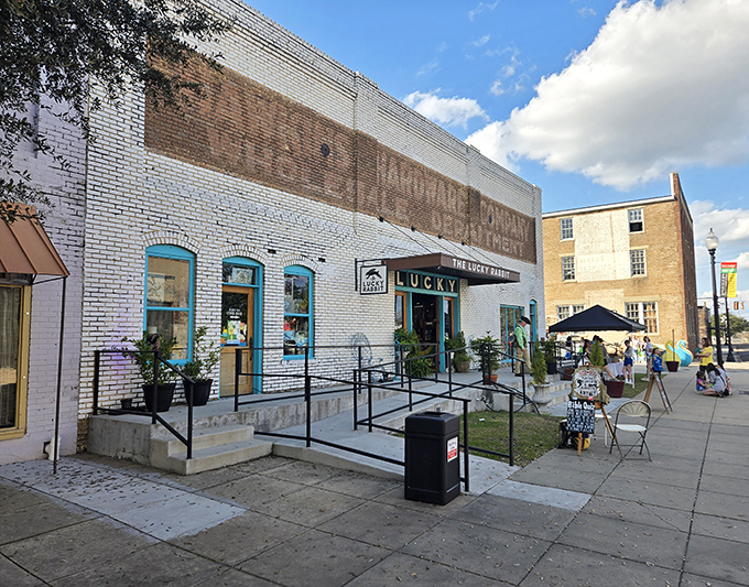 The historic brick facade of The Lucky Rabbit welcomes treasure hunters with its charming blue-trimmed windows and accessibility ramp&mdash;architectural eye candy for vintage lovers.
