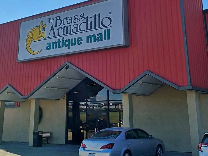 The distinctive red exterior of Brass Armadillo stands like a beacon for treasure hunters, promising adventures in nostalgia just beyond those doors.
