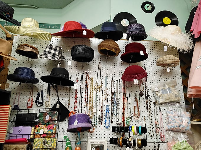 A hat lover's dream display! Vintage styles from flapper-era cloches to Kentucky Derby showstoppers, with vinyl records keeping watch from above.