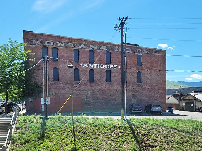 The iconic brick exterior of Montana Antique Mall stands like a sentinel of nostalgia against Missoula's blue sky, beckoning treasure hunters with its vintage charm.