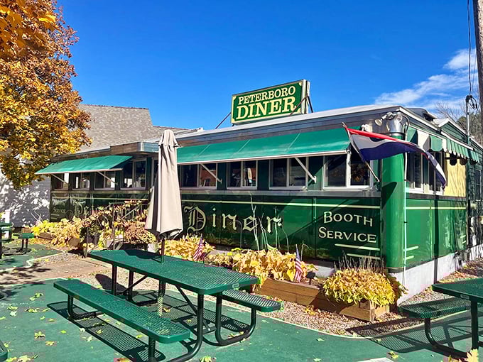 Fall's golden embrace makes this vintage diner even more inviting, with autumn leaves creating nature's welcome mat for hungry visitors.