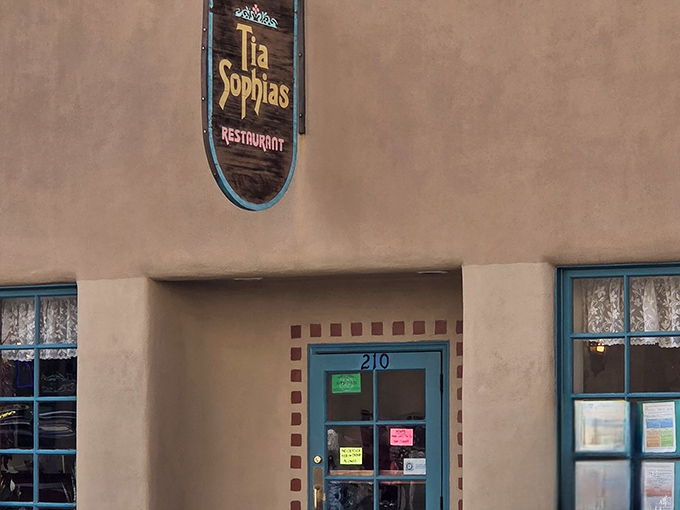 The iconic wooden sign with turquoise trim announces your arrival at Santa Fe's breakfast burrito birthplace. Simple, unassuming, legendary.