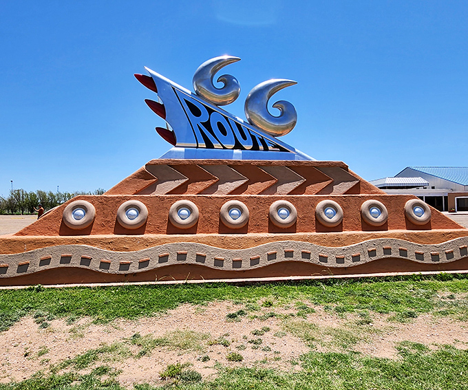 Under that famous blue New Mexico sky, the monument's silver swooshes catch sunlight like a '57 Chevy's polished trim.