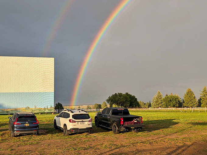 Mother Nature puts on her own show with a perfect rainbow arching over the iconic screen. Movie magic before the film even starts!