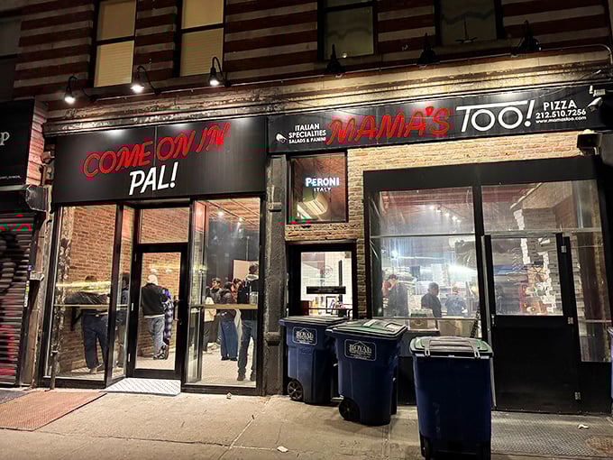 "COME ON IN PAL!" isn't just a sign—it's the most honest invitation on Broadway. This tiny storefront packs more pizza promise than places triple its size.