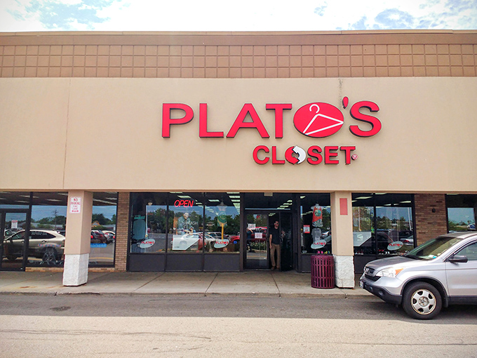 By night, the neon glow transforms Plato's Closet into a beacon of budget fashion. Like moths to a flame, thrift enthusiasts flock to this after-hours fashion oasis.