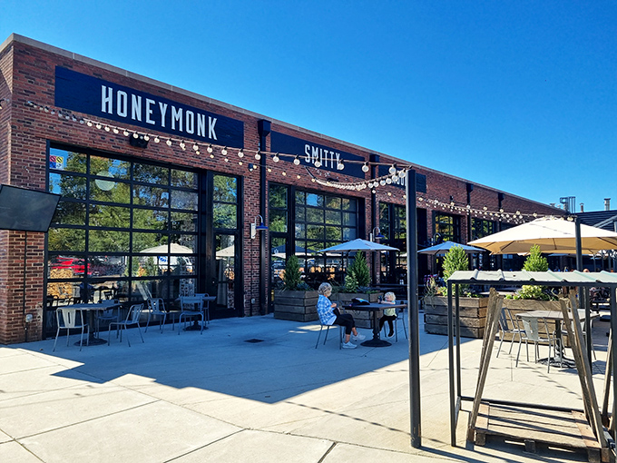 The brick exterior of Noble Smoke promises barbecue greatness with understated confidence. String lights hint at the warm welcome waiting inside.