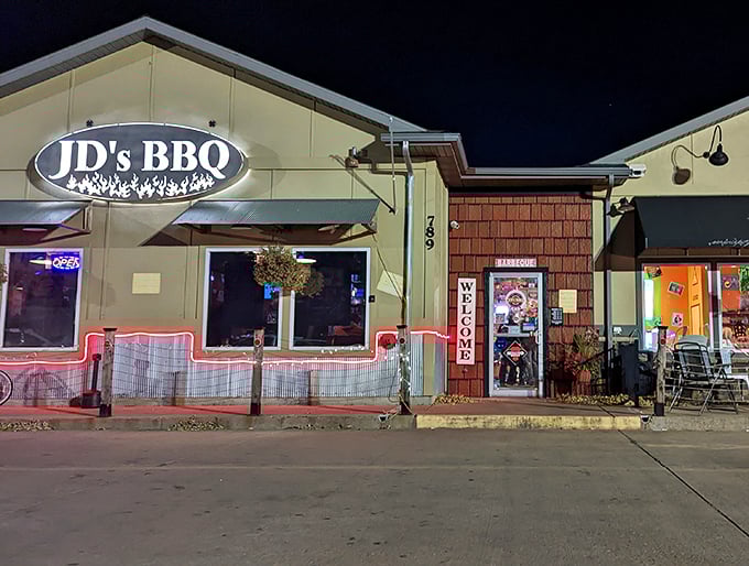 JD's BBQ lights up the Dickinson night like a smoky beacon, calling hungry travelers with its illuminated sign and welcoming red-lit entrance.