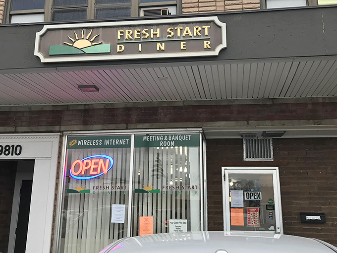 The unassuming storefront of Fresh Start Diner beckons with its cheerful sun logo and promise of morning salvation for the hungry traveler.
