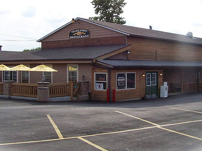 The unassuming wooden exterior of Village Family Restaurant stands like a breakfast beacon in Waynesville, promising homestyle comfort without the fanfare.