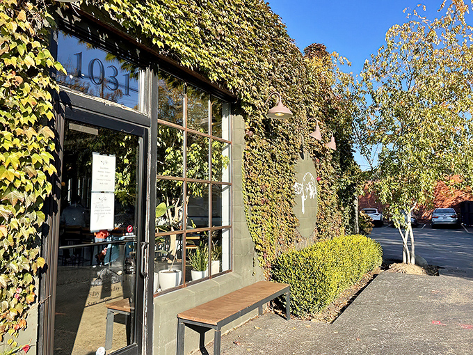 Address proudly displayed, this ivy-embraced entrance beckons with promises of caffeinated treasures and pastry pleasures waiting just beyond those windows.