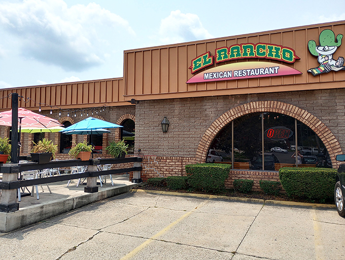 El Rancho's unassuming exterior hides culinary treasures like a pi&ntilde;ata saves its candy. Those colorful umbrellas hint at the fiesta waiting inside.