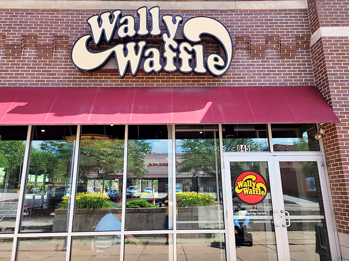 The iconic Wally Waffle sign beckons breakfast enthusiasts like a yellow brick road leading to the promised land of perfect pancakes.