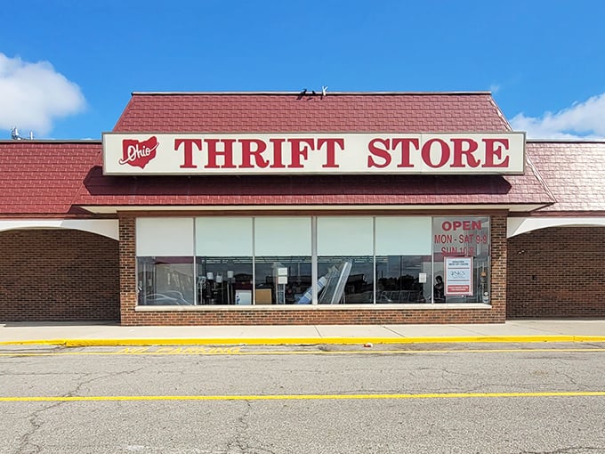The iconic red-roofed Ohio Thrift Store stands like a treasure chest waiting to be opened, promising adventures in affordability under that bright blue Columbus sky.