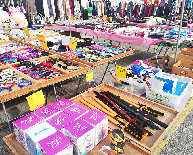 Tables stretching to infinity, each one a universe of possibilities. Yellow price tags announce bargains while colorful treasures await their next chapter.