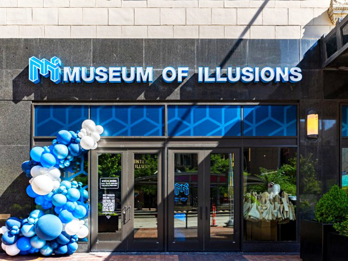 Blue and white balloons frame the sleek entrance, creating their own optical illusion against the modern fa&ccedil;ade of this downtown Cleveland gem. 