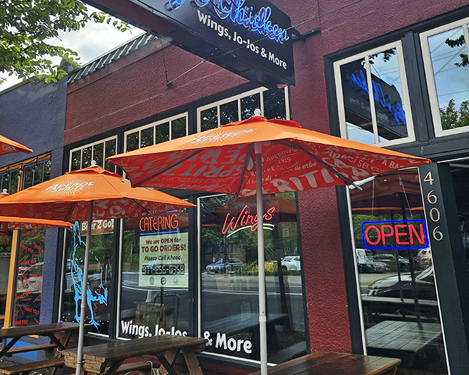 The neon-blue sign beckons like a lighthouse for the hungry. Orange umbrellas promise a spot to savor that famous chicken in Portland's fickle sunshine.