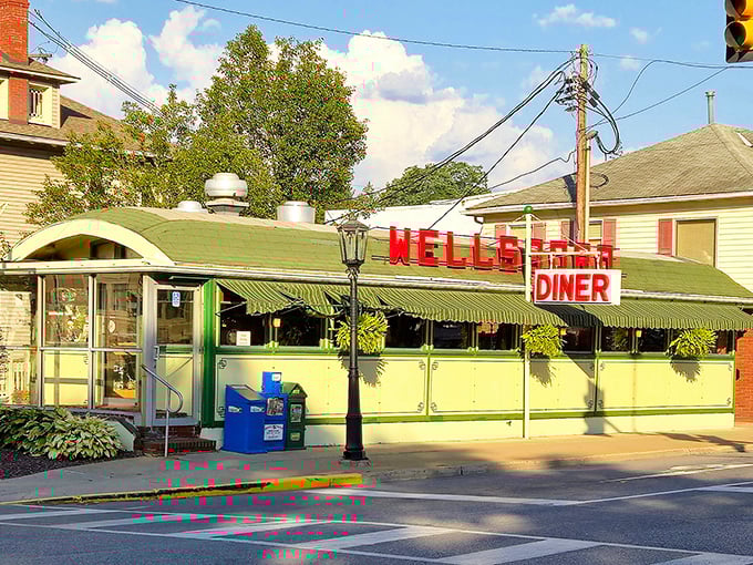 The iconic mint-green exterior of Wellsboro Diner stands like a time capsule on Main Street, its vintage charm beckoning hungry travelers with promises of comfort food perfection.