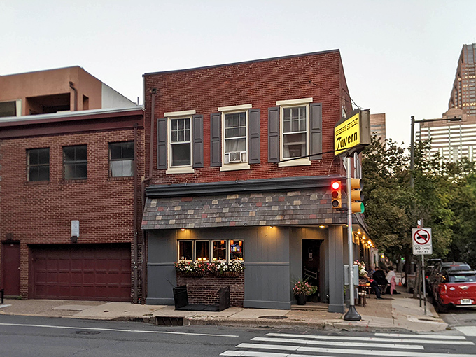 The unassuming brick exterior of Cherry Street Tavern stands like a time capsule amid Philadelphia's urban landscape, its vintage sign promising authentic experiences inside.
