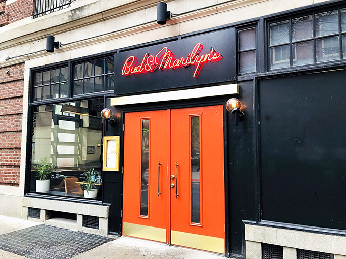 That iconic orange door against the black exterior is like a beacon for hungry souls wandering Philadelphia's Midtown Village. The neon sign promises good things await.