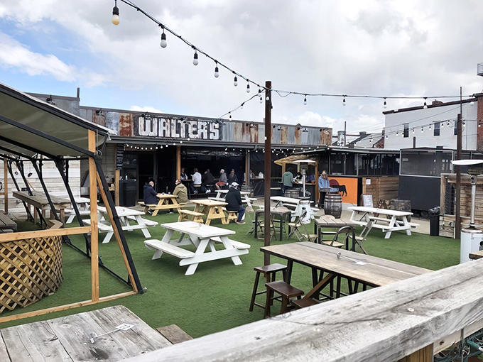 The outdoor oasis at Walter's beckons with picnic tables, string lights, and the promise of smoky delights. BBQ paradise found!