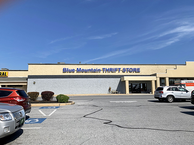 The unassuming exterior of Blue Mountain Thrift Store stands like a treasure chest waiting to be opened, its blue lettering a beacon for bargain hunters.
