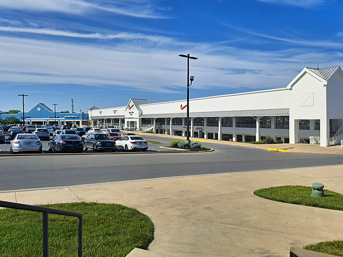 The retail promised land awaits! Tanger Outlets Lancaster's clean white facades gleam under Pennsylvania blue skies, beckoning shoppers to the bargain hunt ahead.