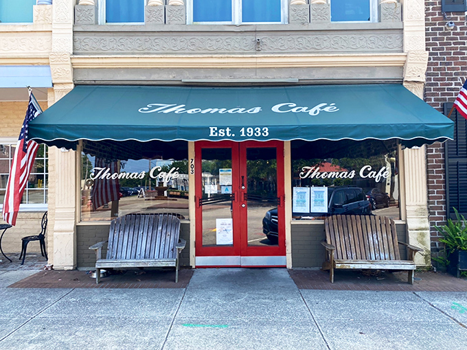 The teal awning and wooden benches of Thomas Cafe aren't just charming—they're sentinels of Southern hospitality that have welcomed hungry Georgetown visitors since 1933.