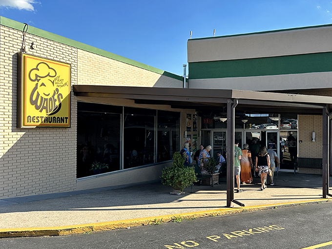 The bright yellow sign beckons like a lighthouse for hungry souls. Wade's Restaurant stands ready to welcome you into its temple of Southern comfort.